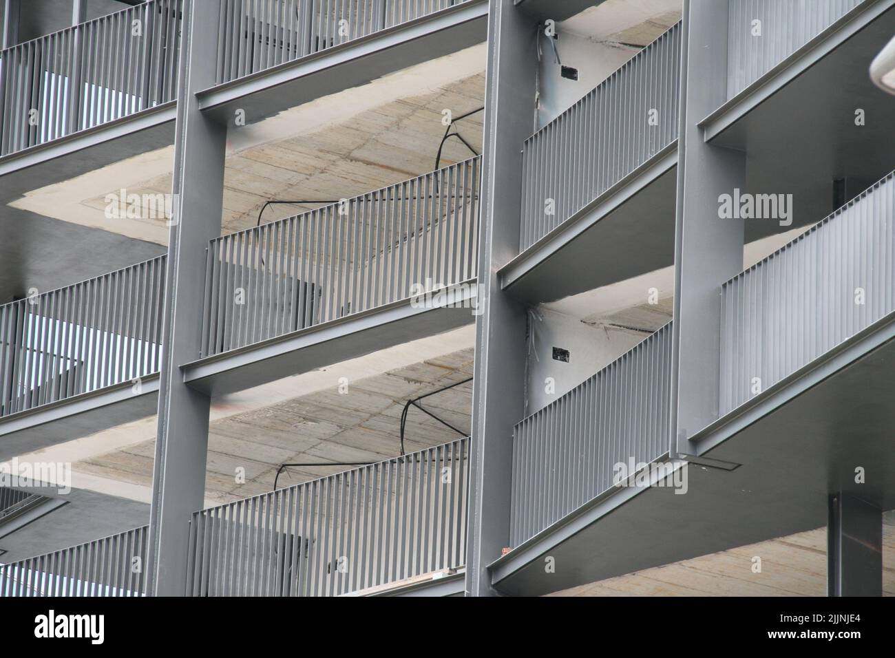 A low angle shot of the floors of a building with gray, metal fences ...