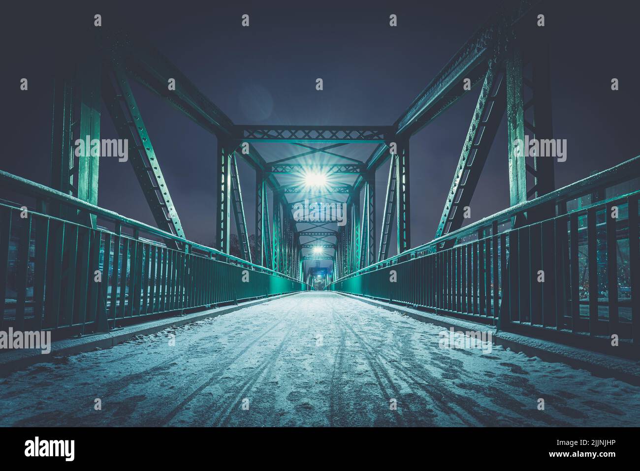 A shot of the old iron bridge during the winter with lights at night ...