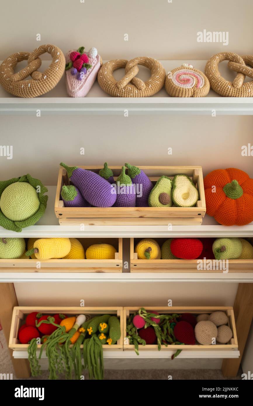 Artificial food in the children's kitchen. On the shelf are vegetables ...