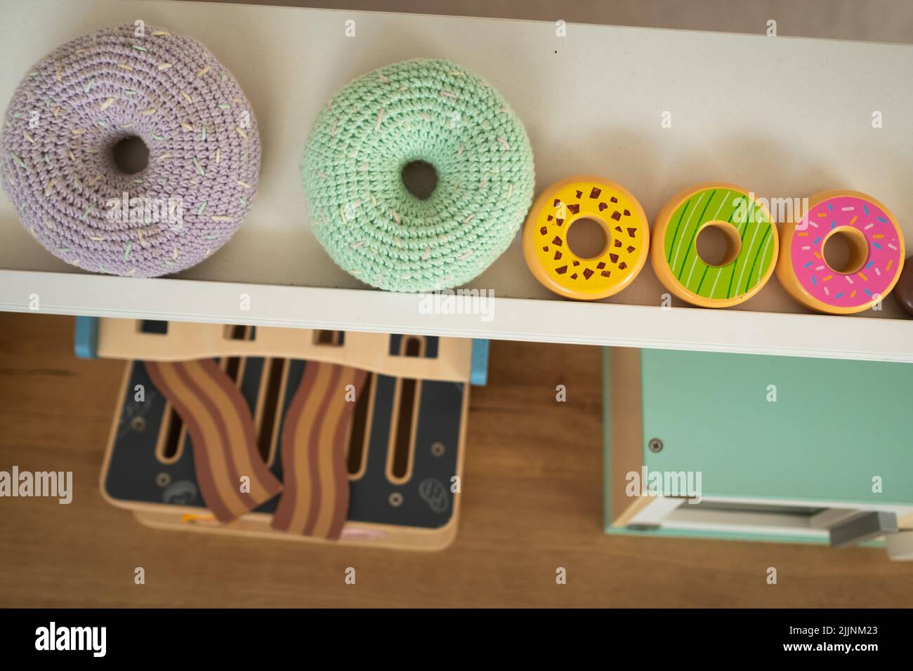 Artificial food in the children's kitchen. On the shelf are vegetables ...