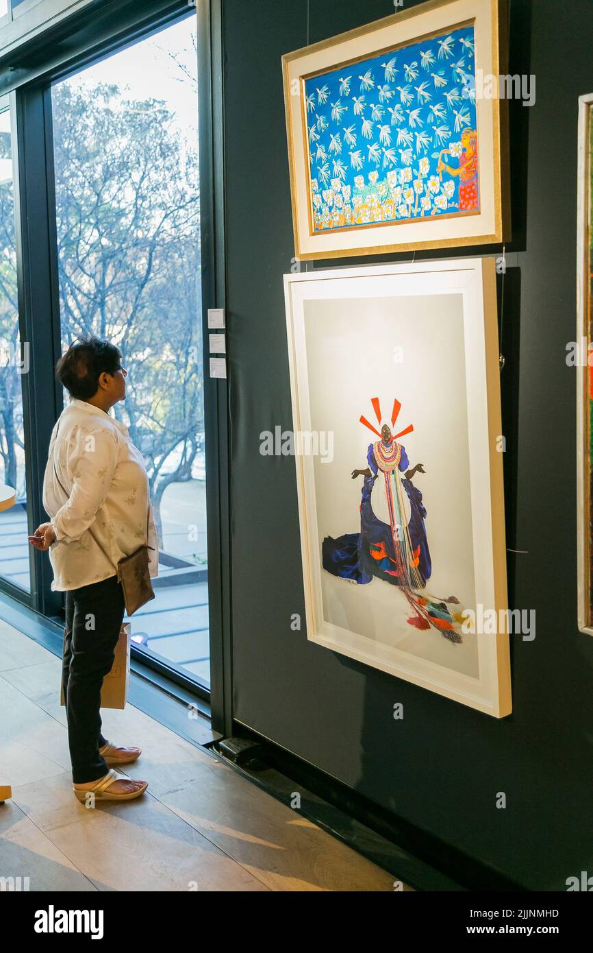 A female viewing the art exhibit in the gallery Stock Photo - Alamy
