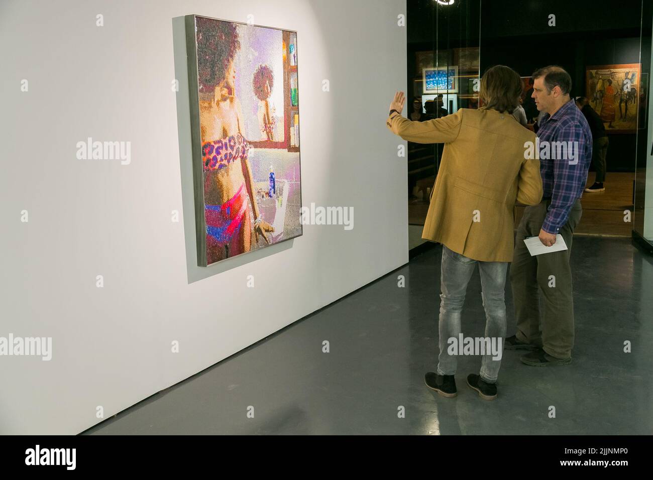 The visitors viewing the art exhibit in the gallery Stock Photo - Alamy