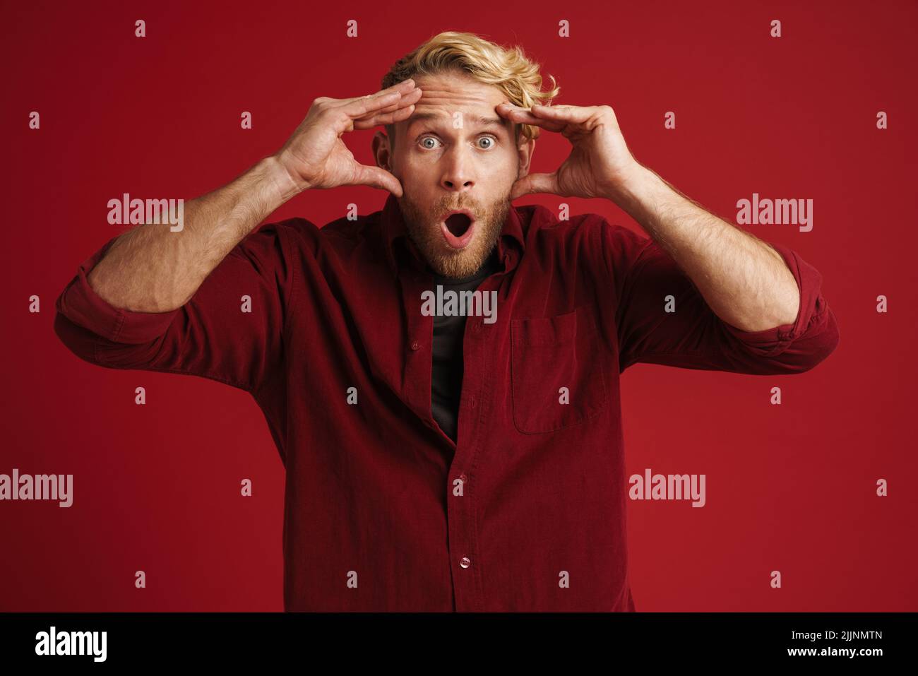 White bearded man expressing surprise while holding his head isolated ...
