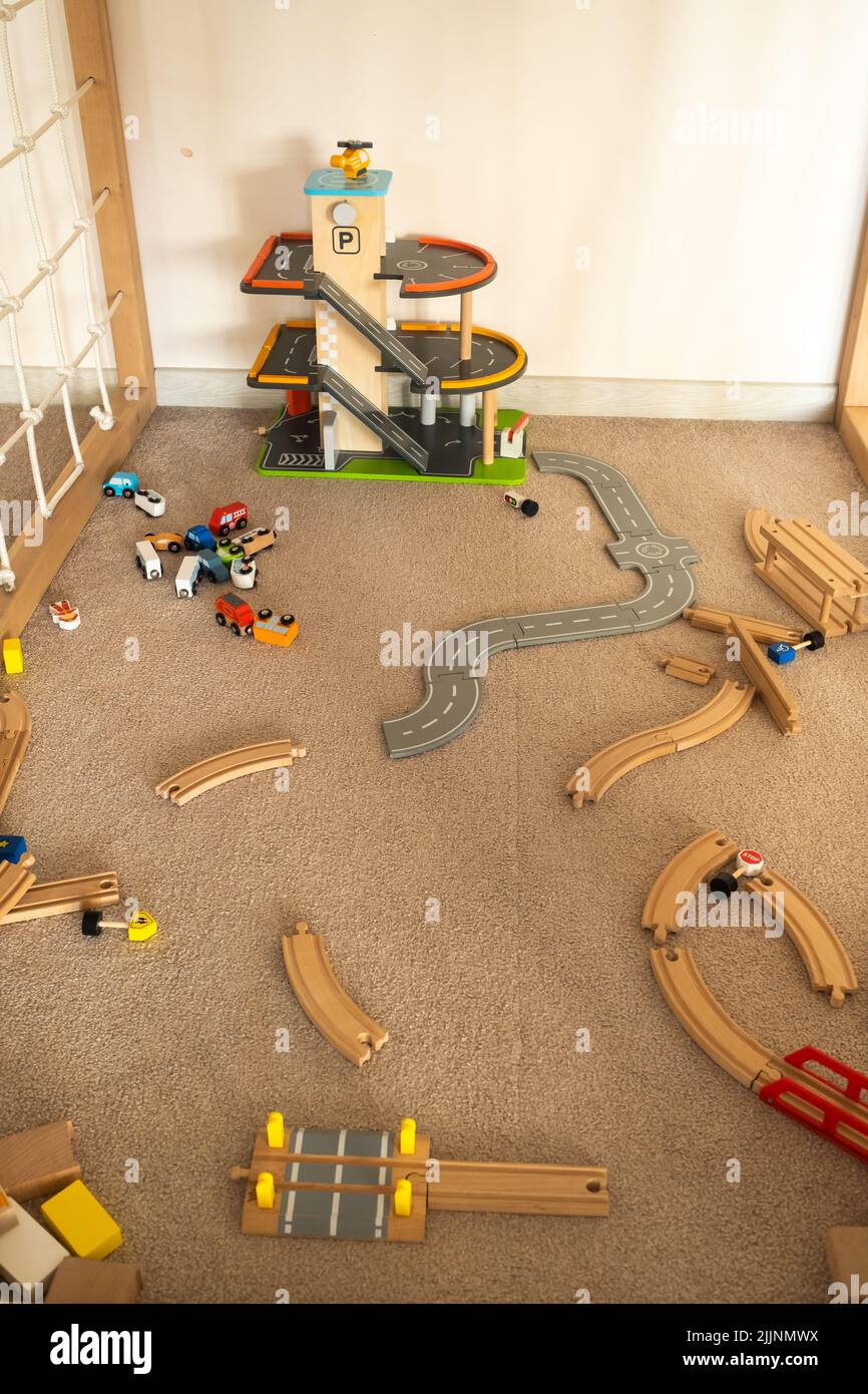 A scattered wooden road construction kit on the floor. Child's play ...
