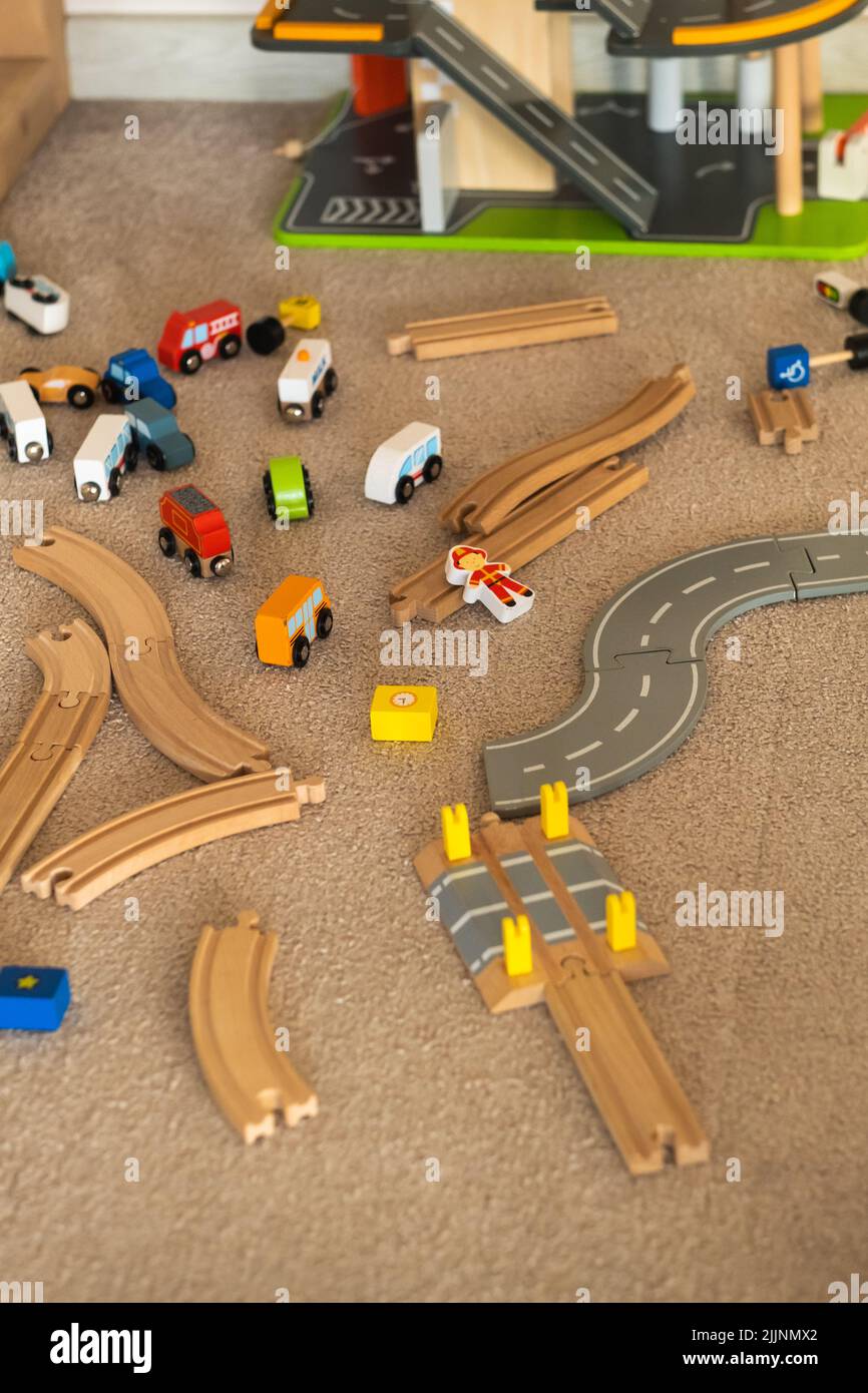 A scattered wooden road construction kit on the floor. Child's play ...