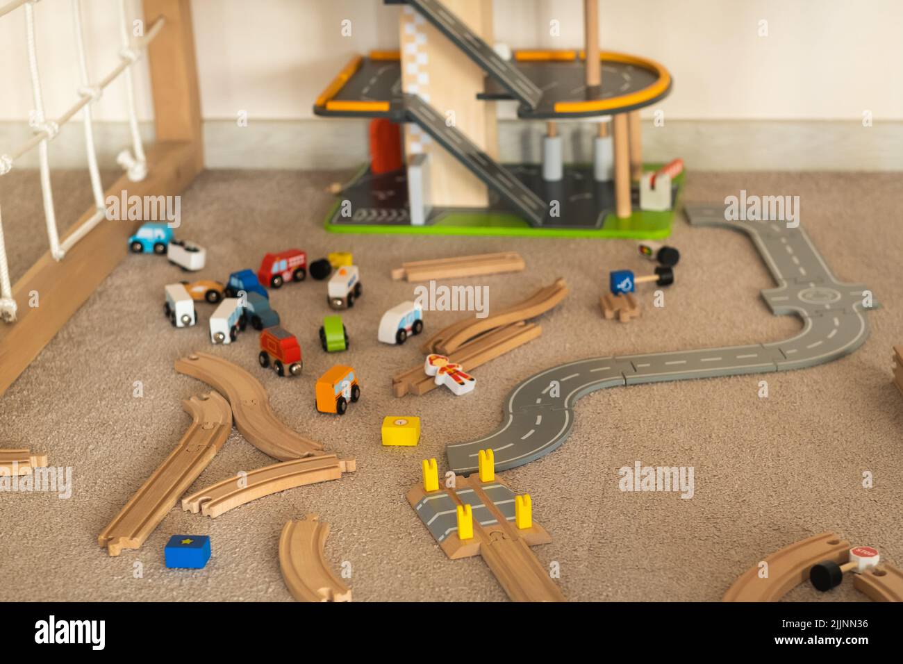 A scattered wooden road construction kit on the floor. Child's play ...