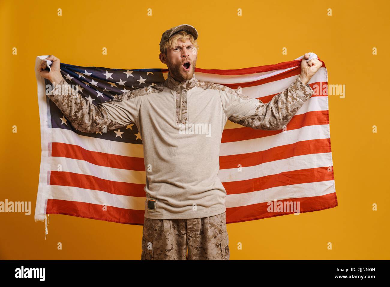 White military man screaming while posing with american flag isolated ...