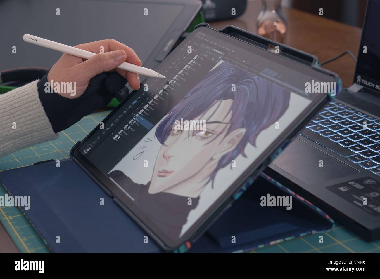 Young asian graphic designer working on computer and drawing digital ...