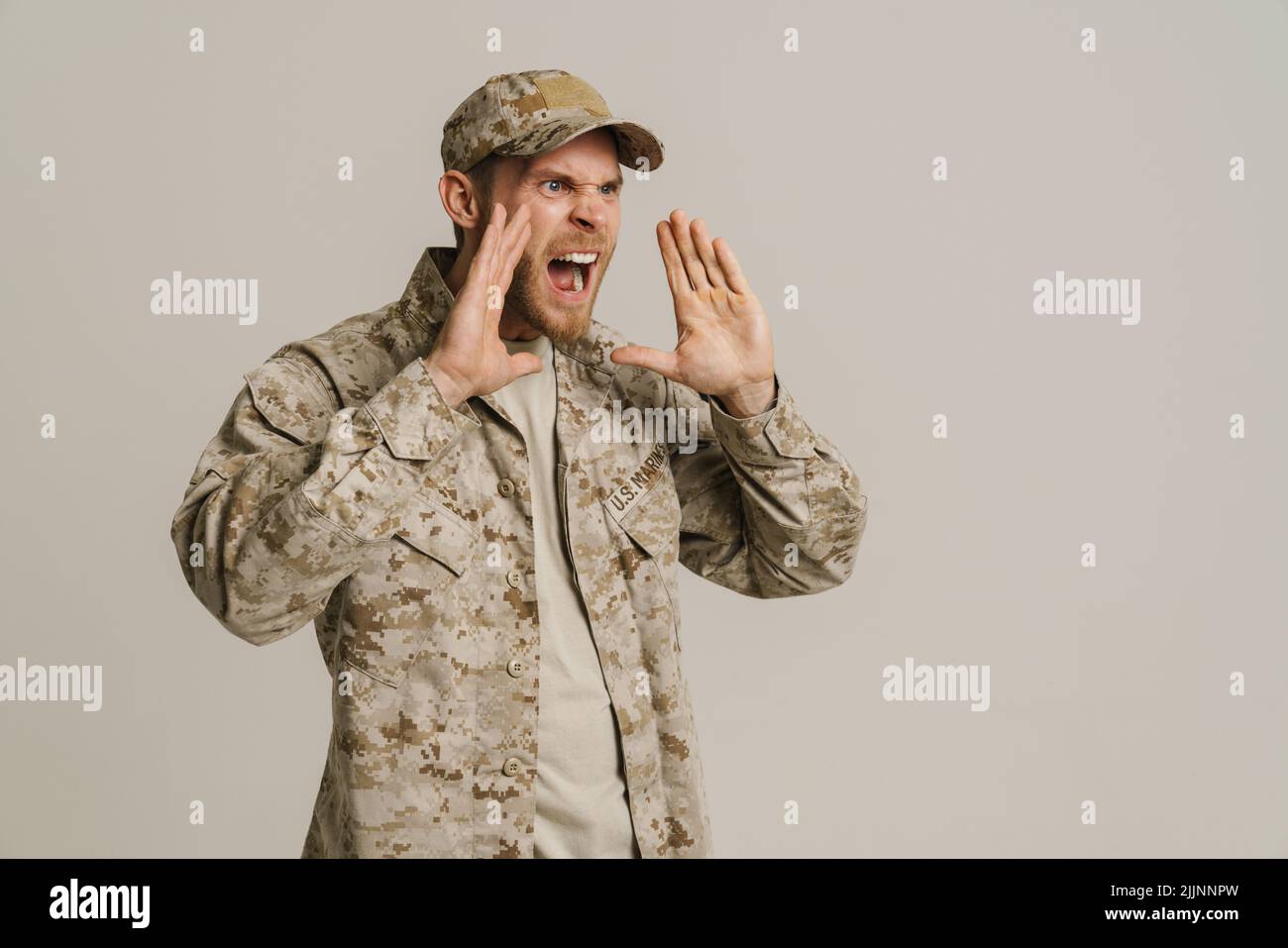 Furious military man wearing uniform gesturing and screaming isolated ...