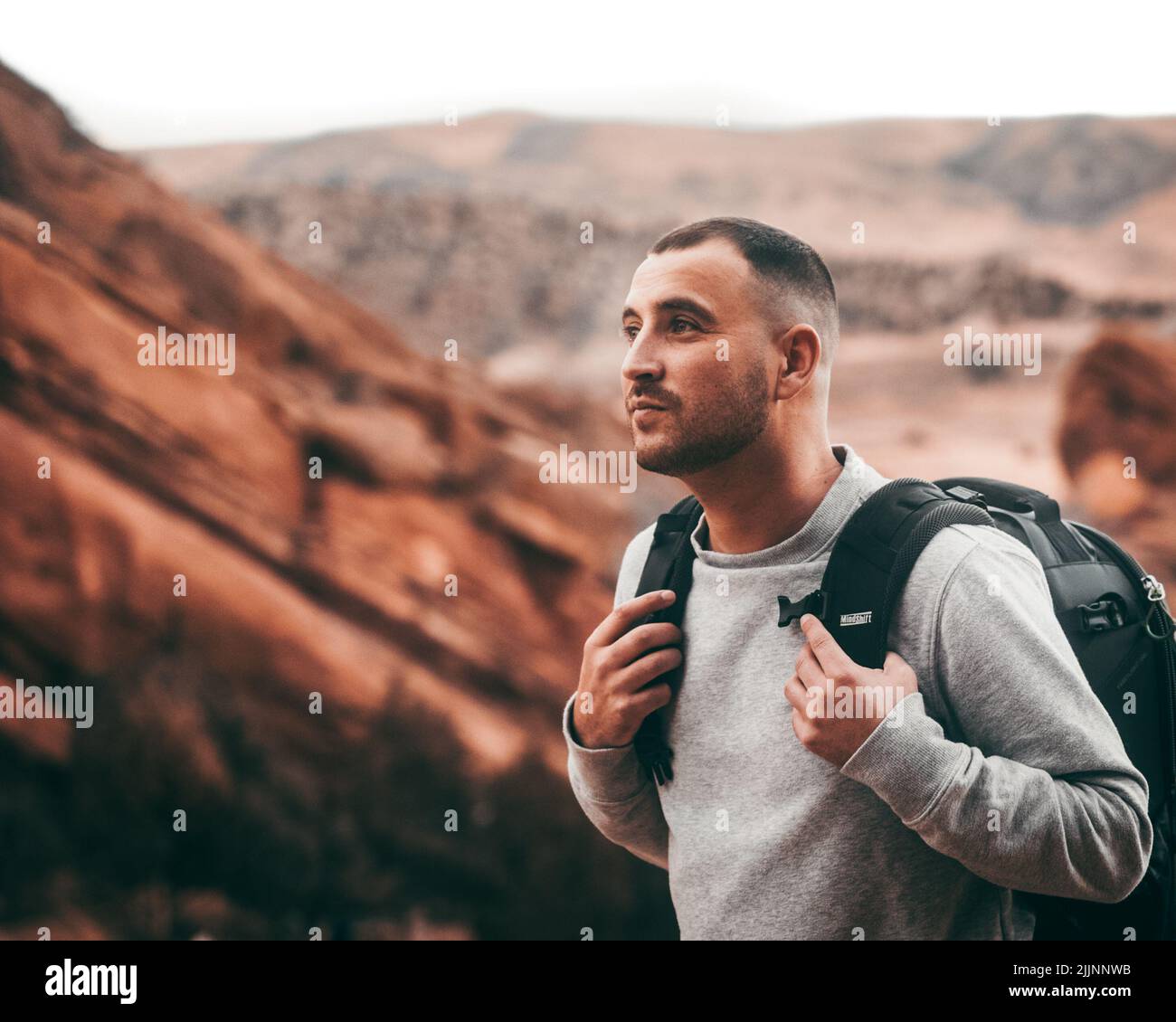 An attractive man hiking at the beautiful Red Rocks Park and ...