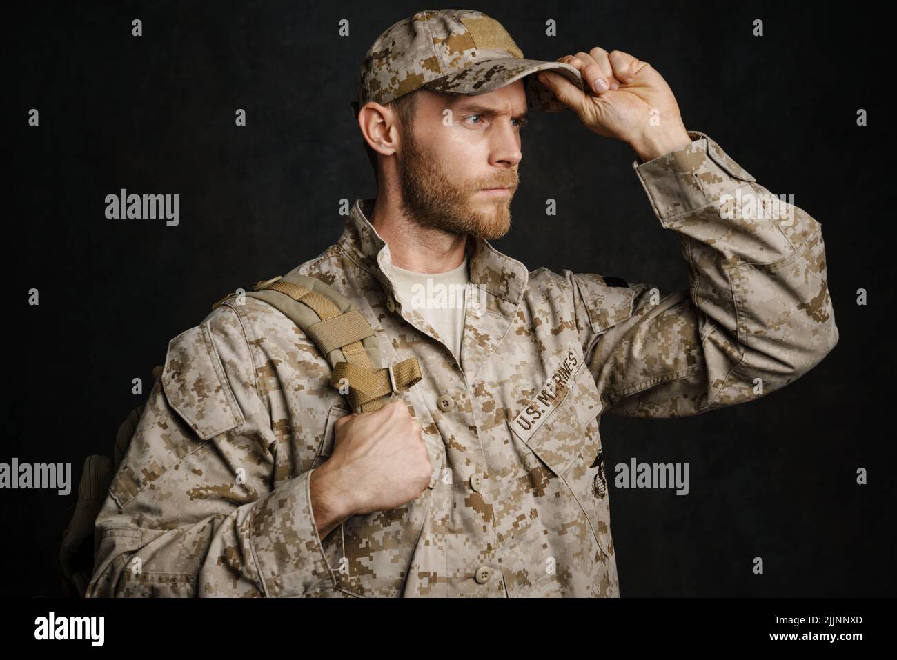 White military man wearing uniform posing with backpack isolated over ...
