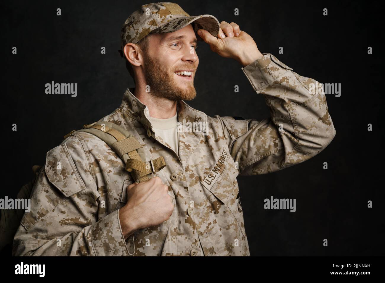White military man wearing uniform posing with backpack isolated over ...