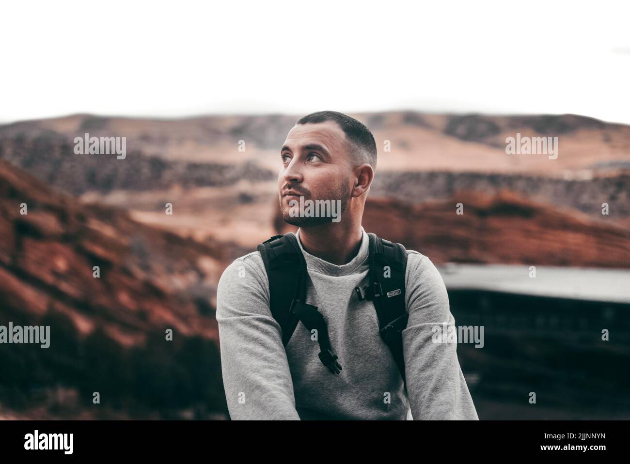 An attractive man hiking at the beautiful Red Rocks Park and ...