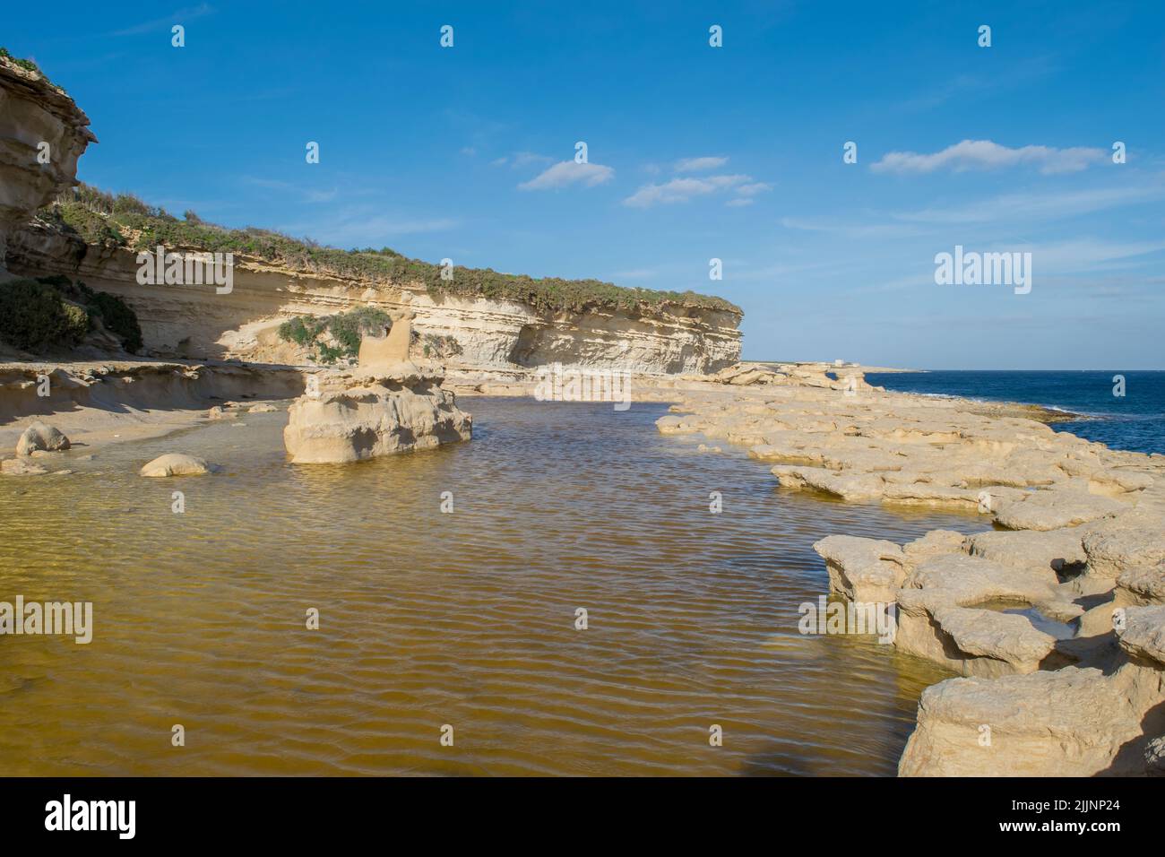 Limestone wave-cut platform along the coast of Delimara, Malta, showing ...