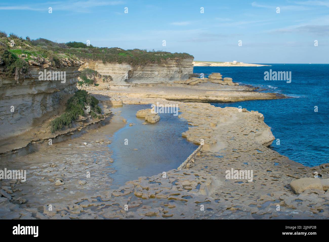 Limestone wave-cut platform along the coast of Delimara, Malta, showing ...