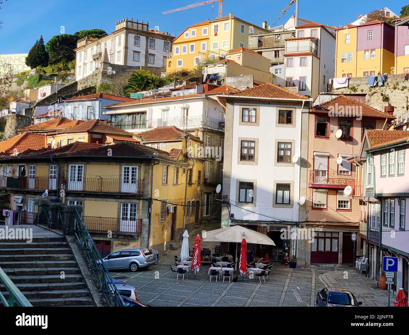 The small city square of Porto surrounded by colorful houses in ...