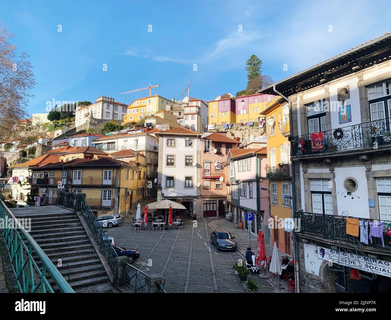 The small city square of Porto surrounded by colorful houses in ...