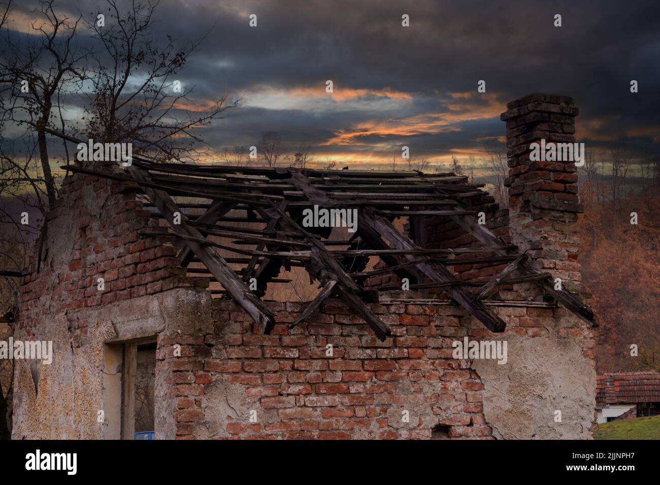 Ruined old spooky haunted house with burned roof and chimney outdoors ...