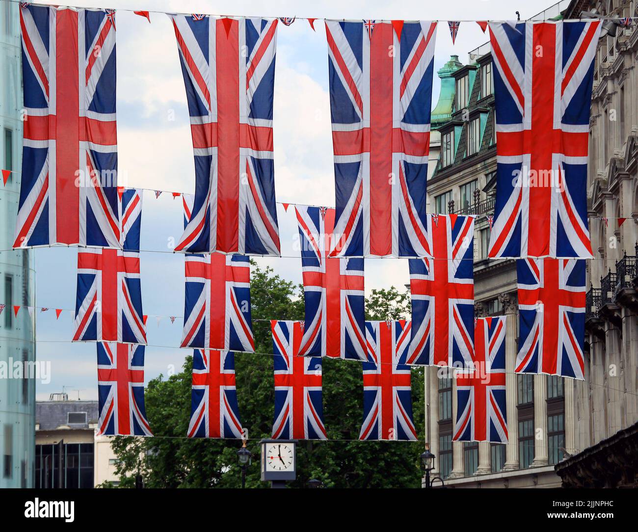 Traditional Union jack British flags hanging outside in London street ...