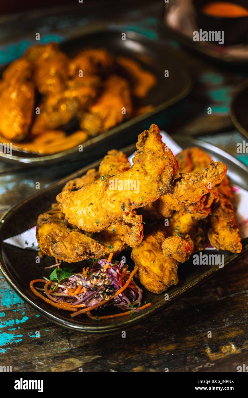 The chicken burger and wings in a dark grungy restaurant setting Stock ...