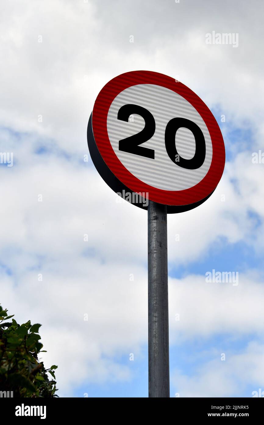 Road sign showing a 20 mph speed limit at the approach to a residential ...