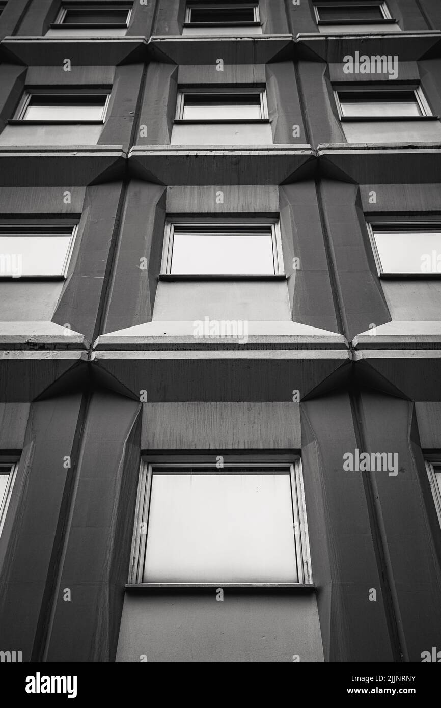 Vertical closeup shot of the facade of abuilding with windows lined ...