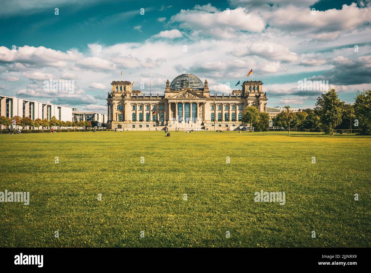 The parliament building of Germany, Reichstag, with a large green field ...