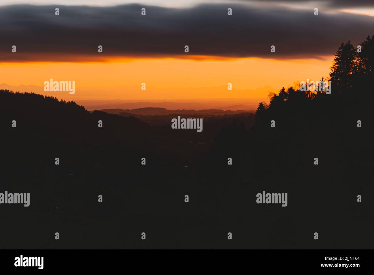 a photo of valley against sunset sky Stock Photo - Alamy