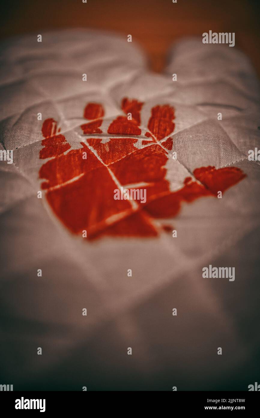 A closeup of a red handprint on a white cloth Stock Photo - Alamy