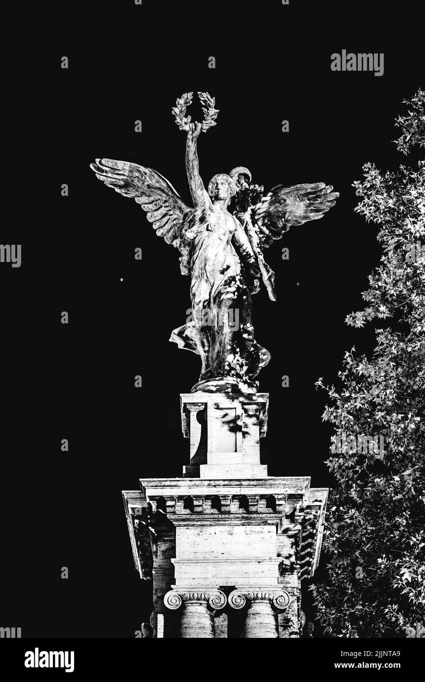 A grayscale of an angel statue in the park Stock Photo - Alamy