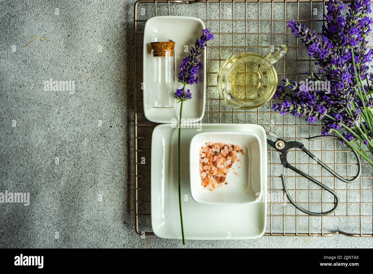 Overhead view of lavender flowers, essential oil and pink Himalayan ...