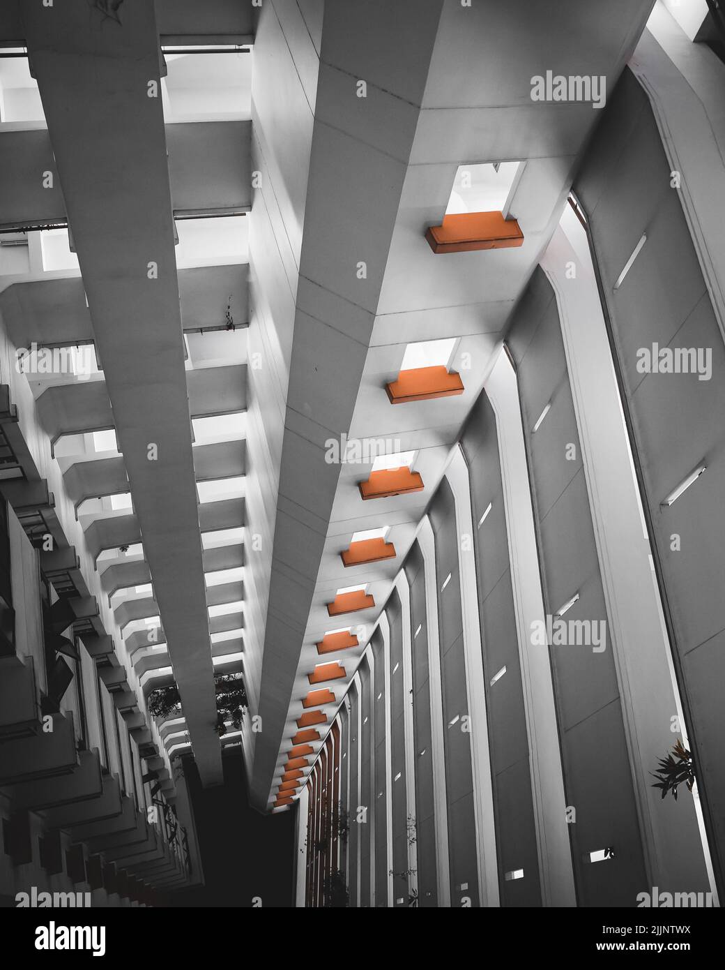 A vertical flipped shot of a tall building in Singapore at night Stock ...