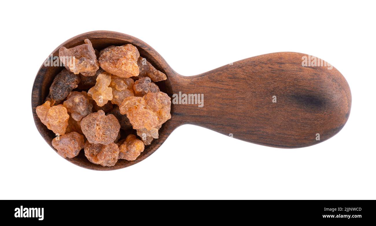 Myrrh resin in wooden spoon, isolated on white background. Pile of ...
