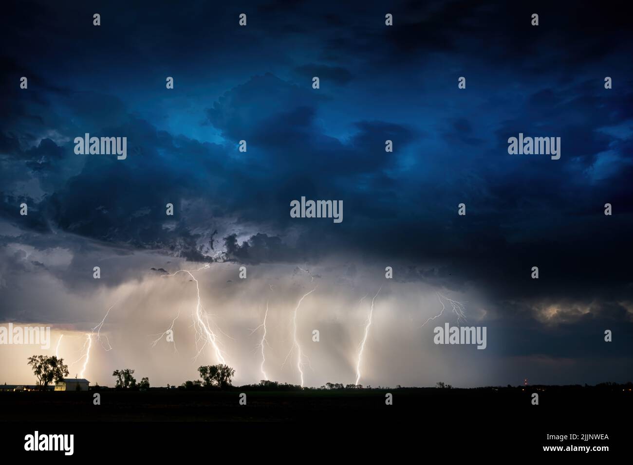 A night thunderstorm under a blue cloudy sky Stock Photo - Alamy