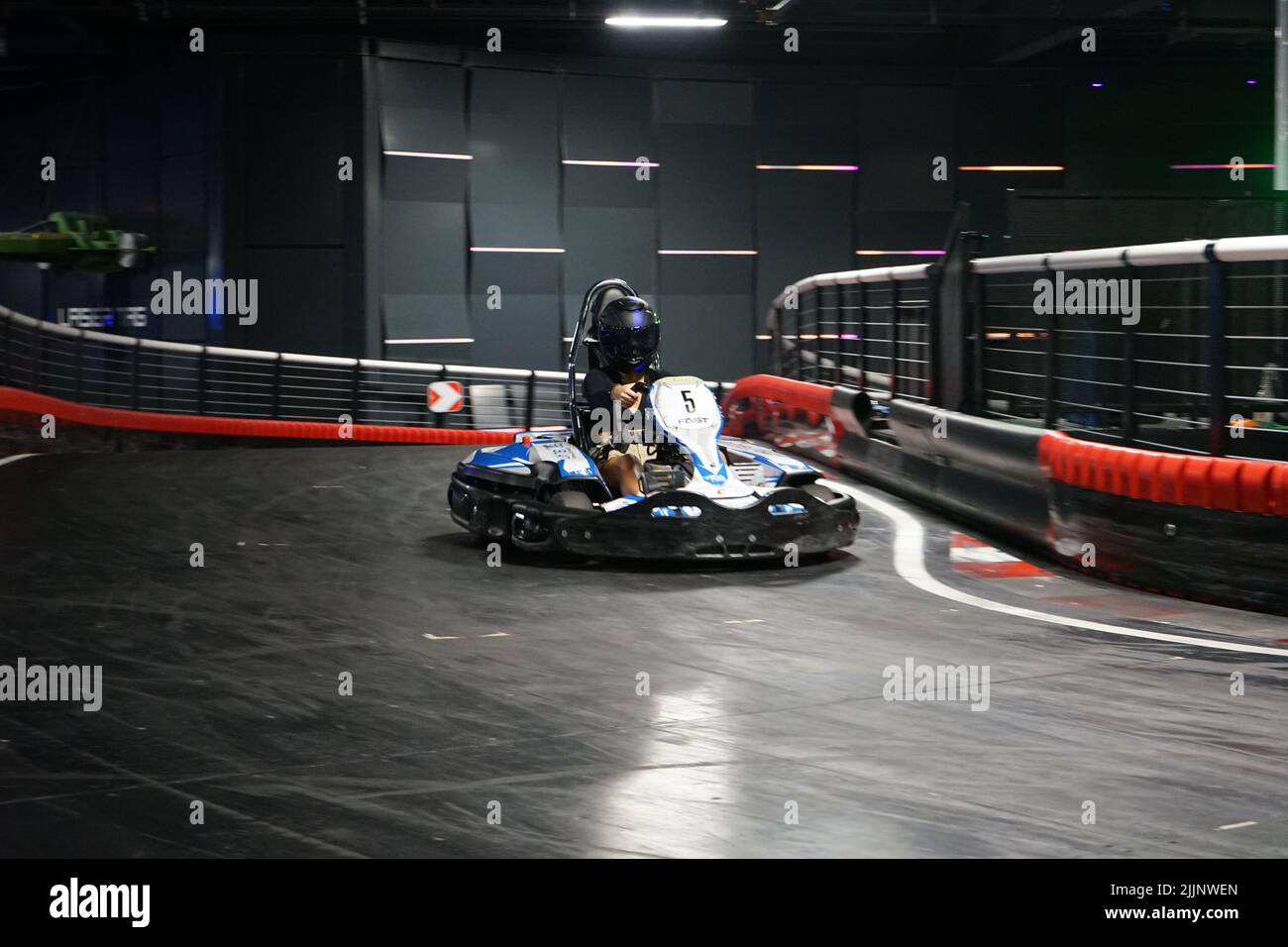 A person go-kart racing on a multi-level track Stock Photo - Alamy