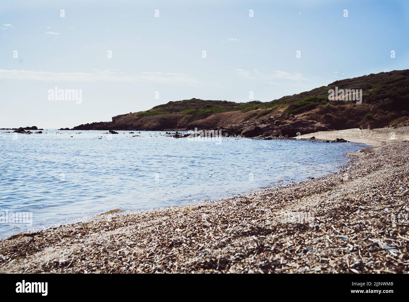 A view of Nora beach surrounded by greenery hills and rocks Stock Photo ...