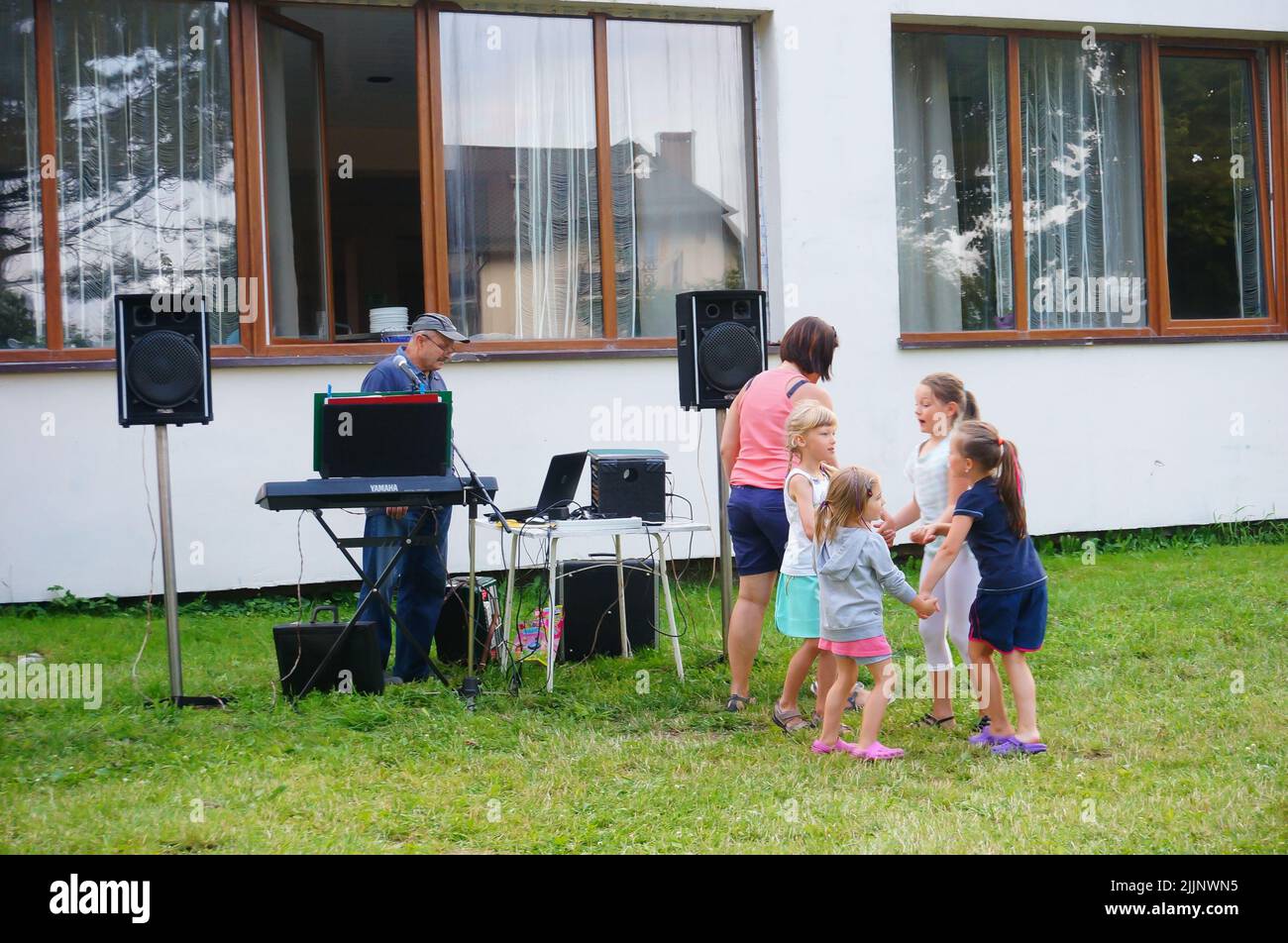 People having fun during a barbecue event by an holiday resort at the ...