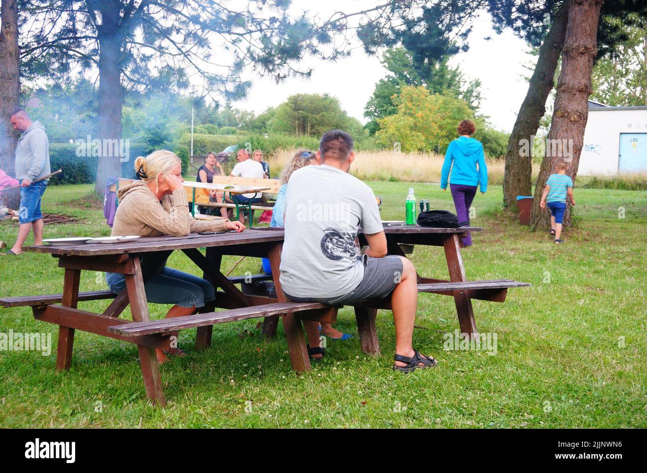 People having fun during a barbecue event by an holiday resort at the ...
