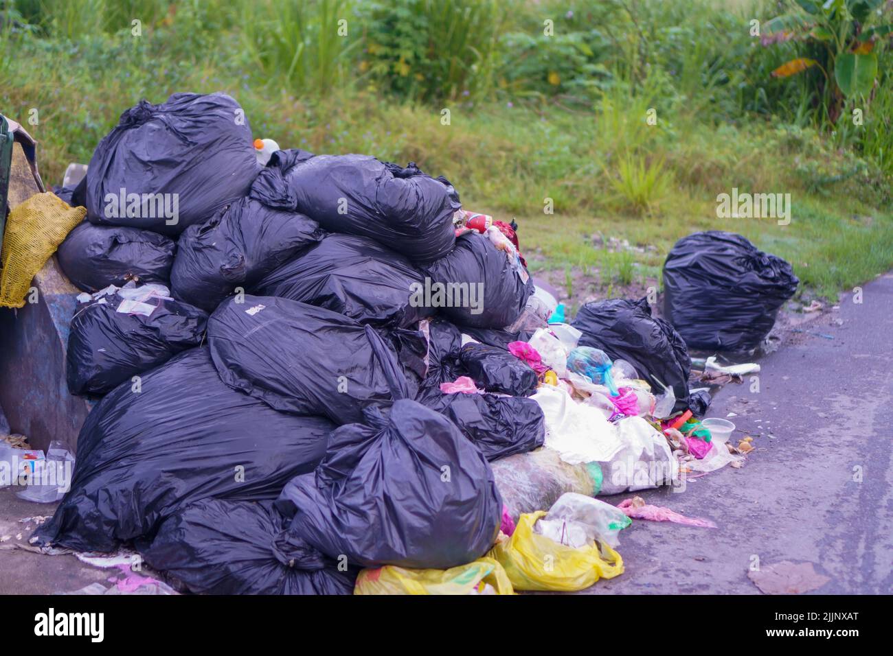 A closeup shot of garbage plastic dump on the side of a road Stock ...