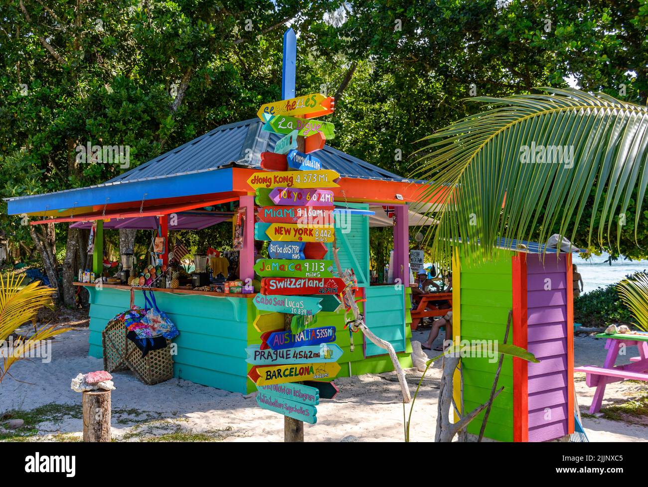 A closeup of a colorful beach bar on a tropical sandy beach on La Digue ...