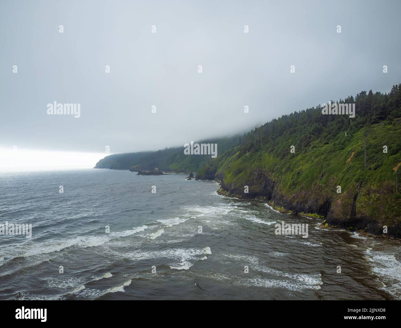 The ocean and mountains on the shore covered with green grass. Beauty ...