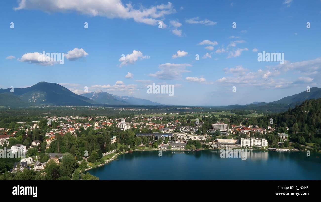 An aerial view of the Bled town and lake during a sunny day in Slovenia ...