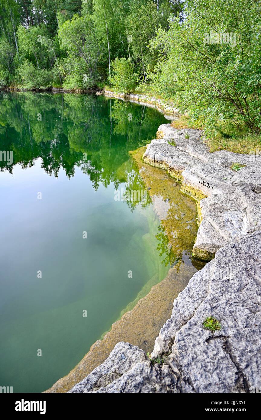 quarry filled with water a summers day Stock Photo - Alamy
