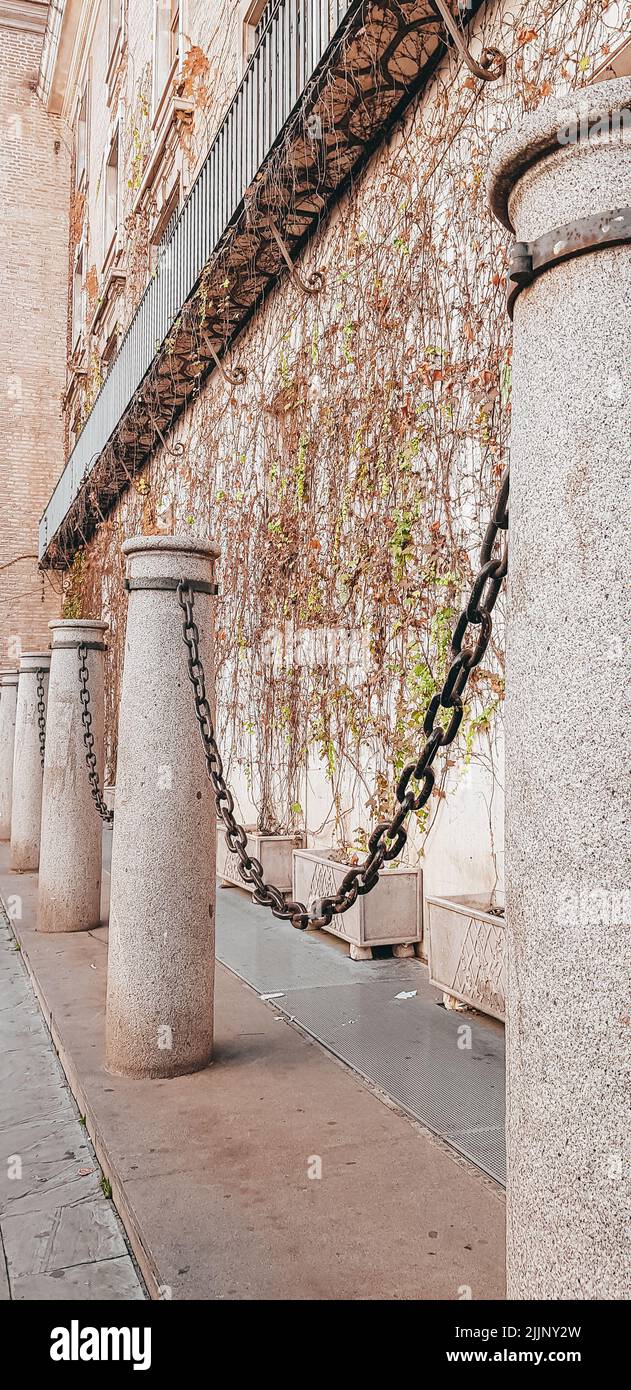 A vertical shot of short columns tied with chains against an old ...