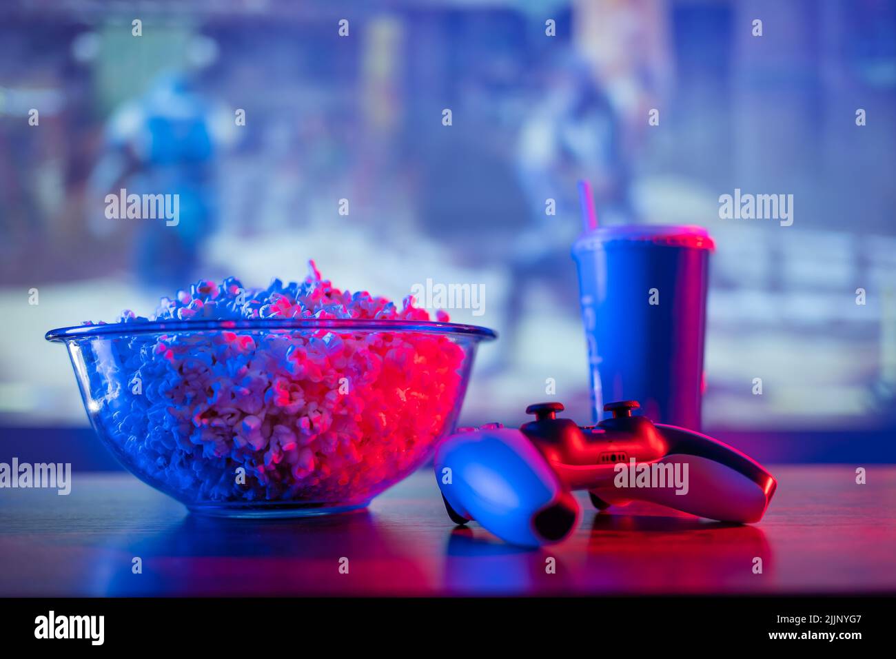 Fast food - popcorn in a glass bowl, a drink in a plastic glass and a ...