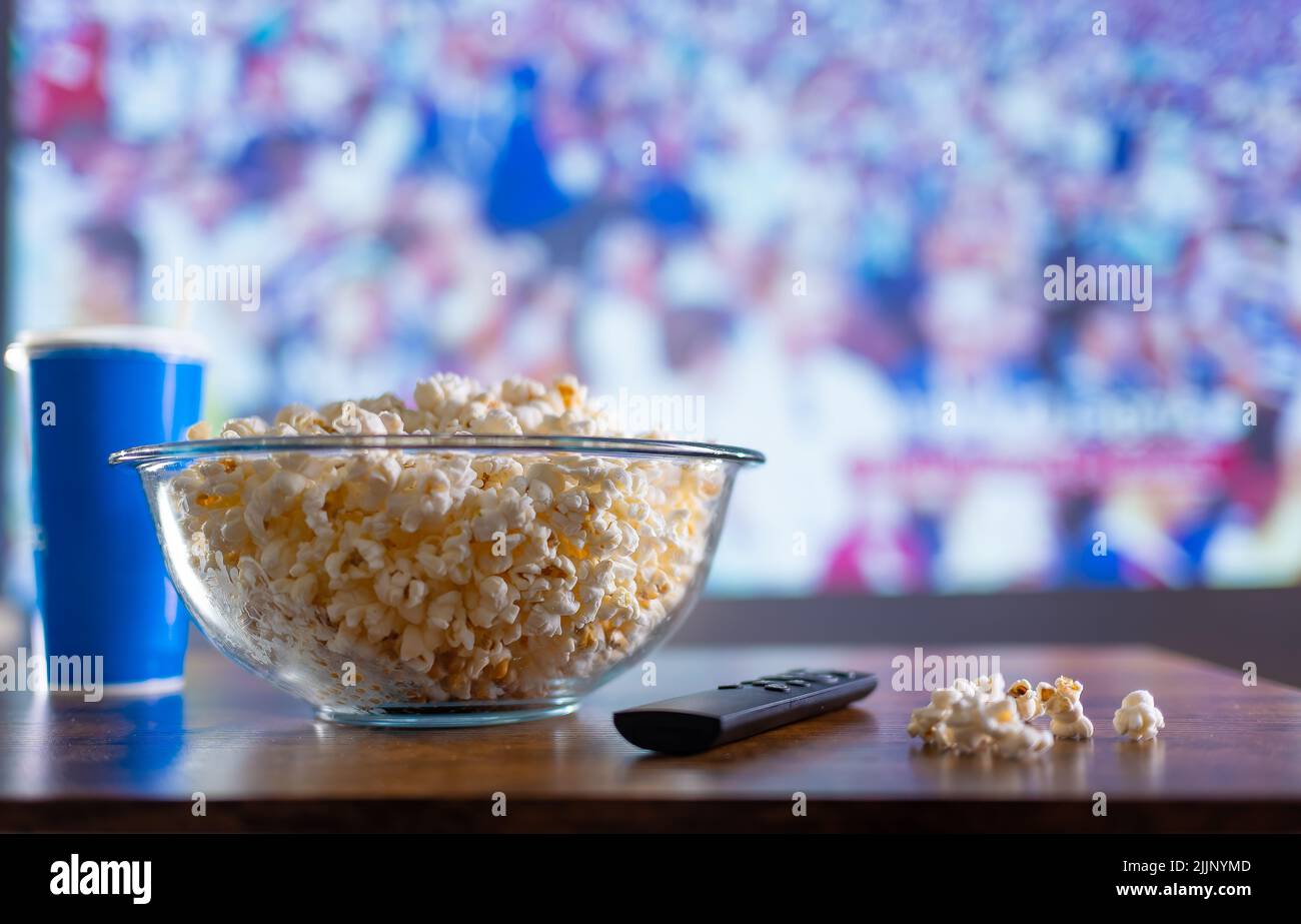 Against the backdrop of the stadium with spectators on the TV screen, a ...