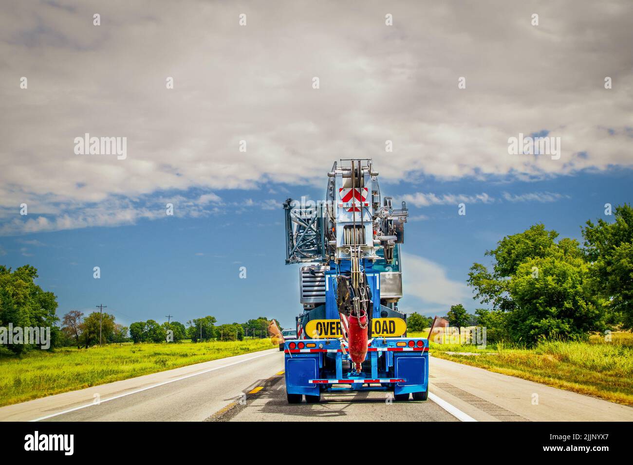 Oil drilling rig on truck driving on two lane ountry road - Overload ...