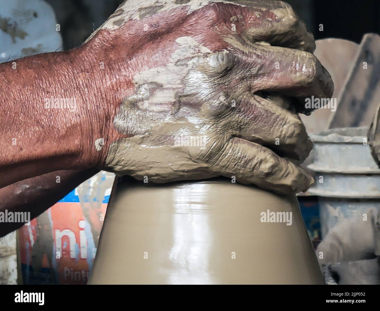 Potter works with piece of clay and in process of creating new piece of ...