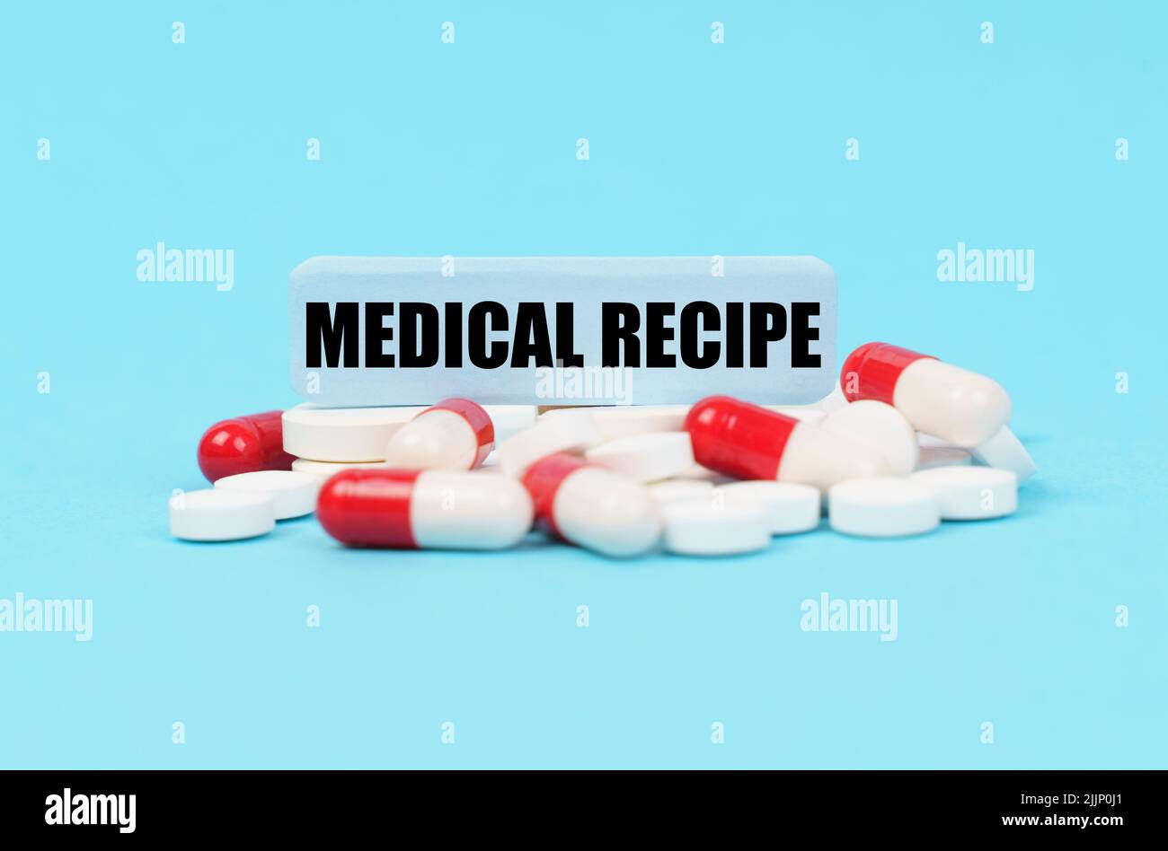 Medical concept. On the blue surface of the pills, capsules and a plate ...