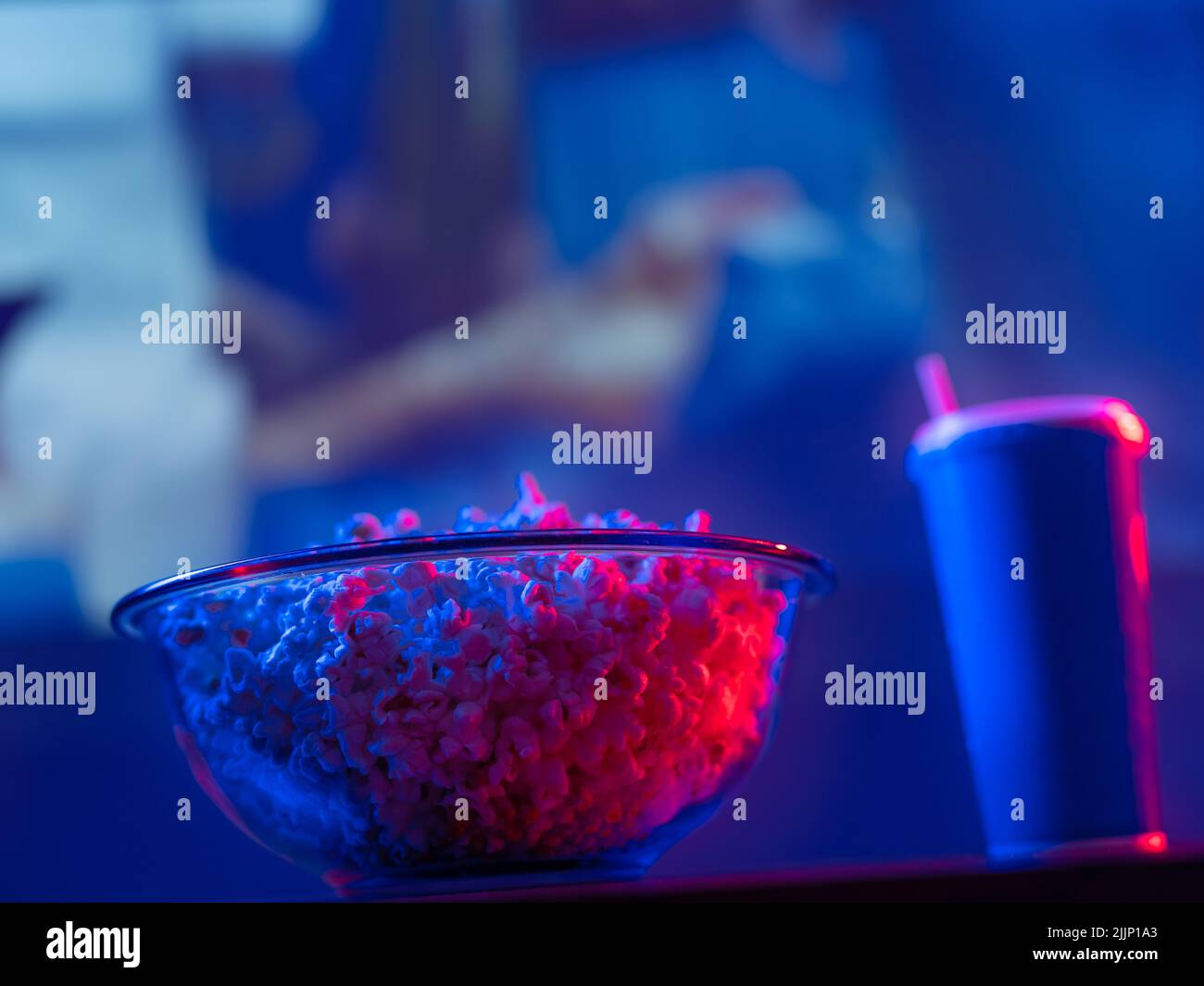 Against the background of the screen of a large plasma TV, a glass bowl ...